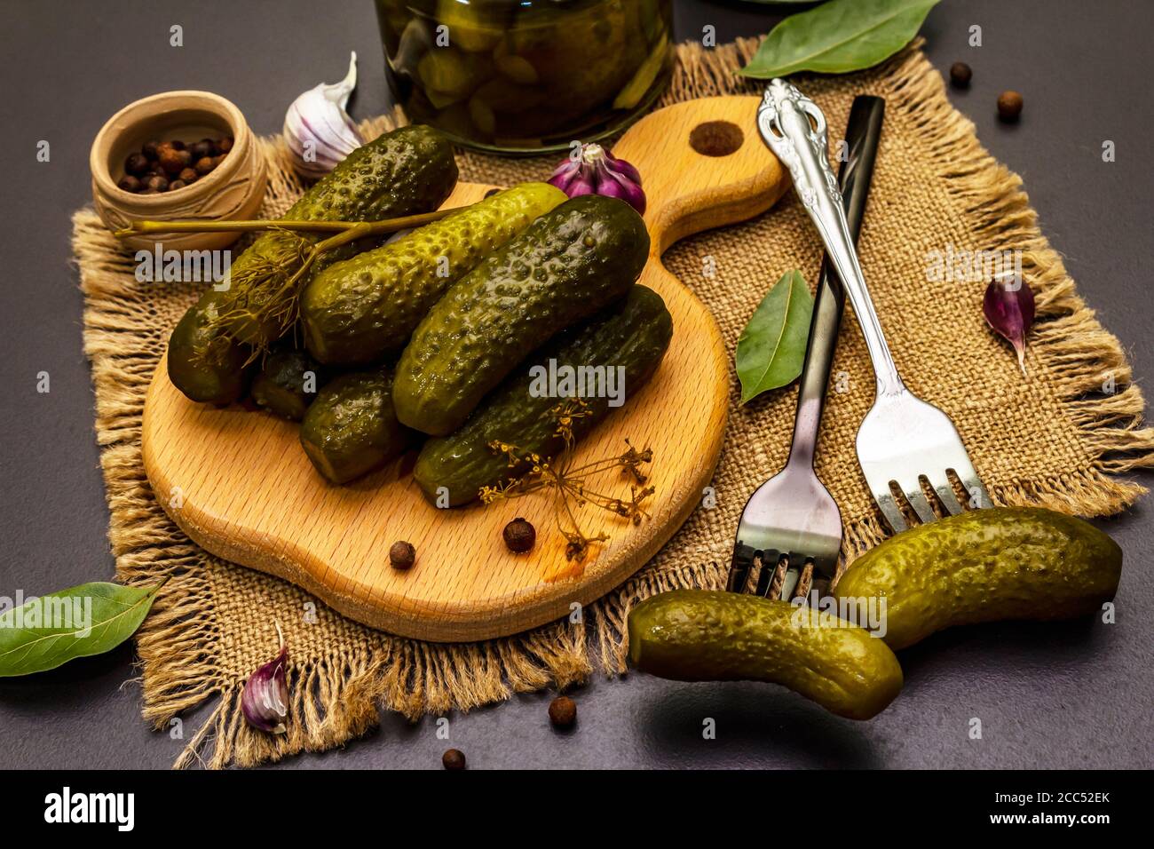 Marinated pickled cucumbers with spices and herbs. Traditional Eastern ...
