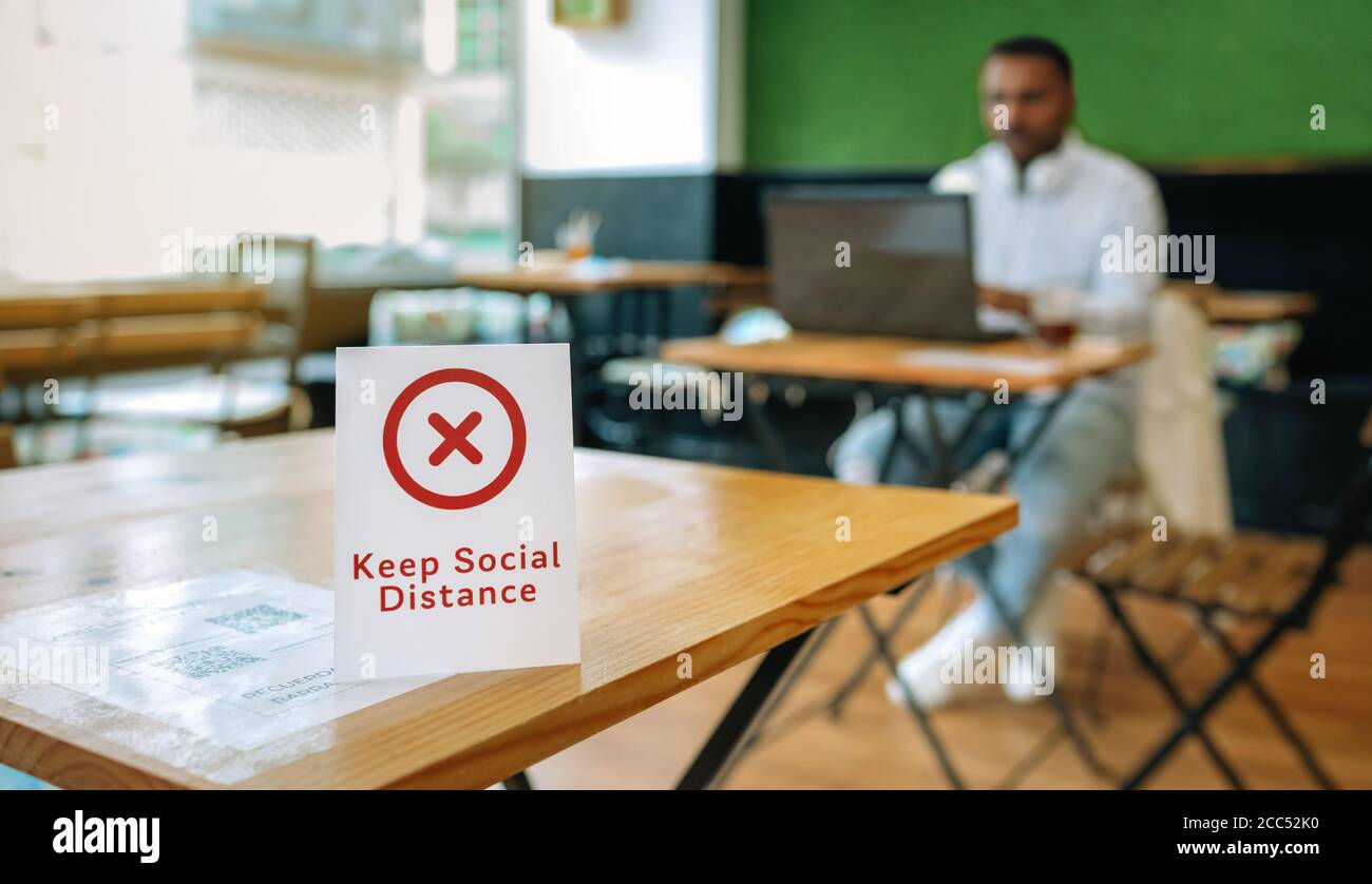 Coffee shop table with do not use sign with man in background Stock ...