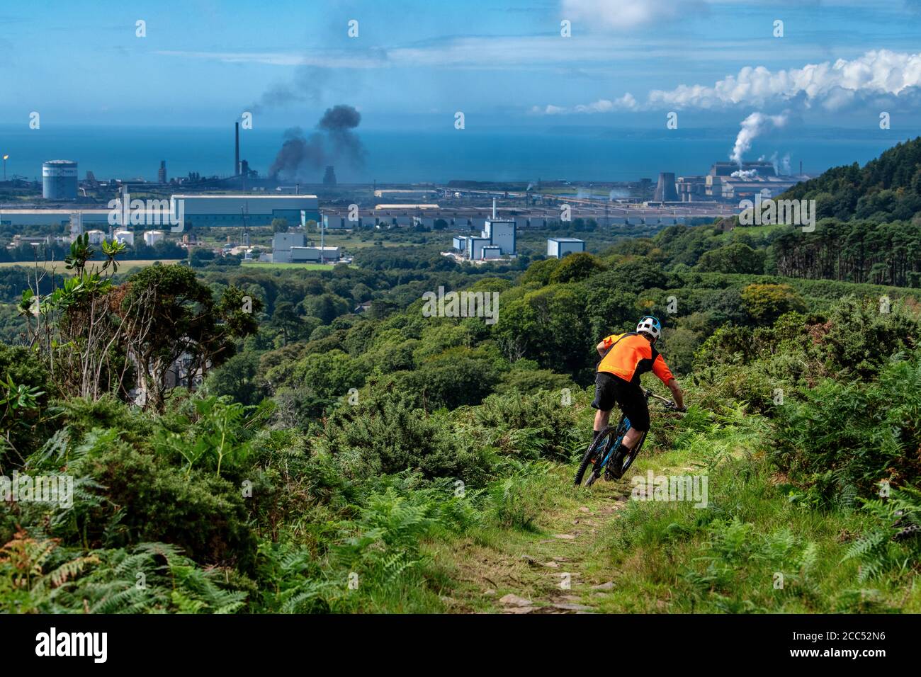 A man rides a mountain bike on a trail at Margam Country Park near Port ...