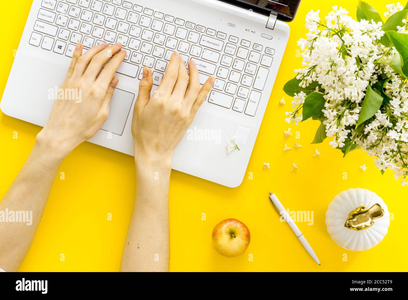 Female hands with laptop. Workplace with jasmine flowers top view Stock ...