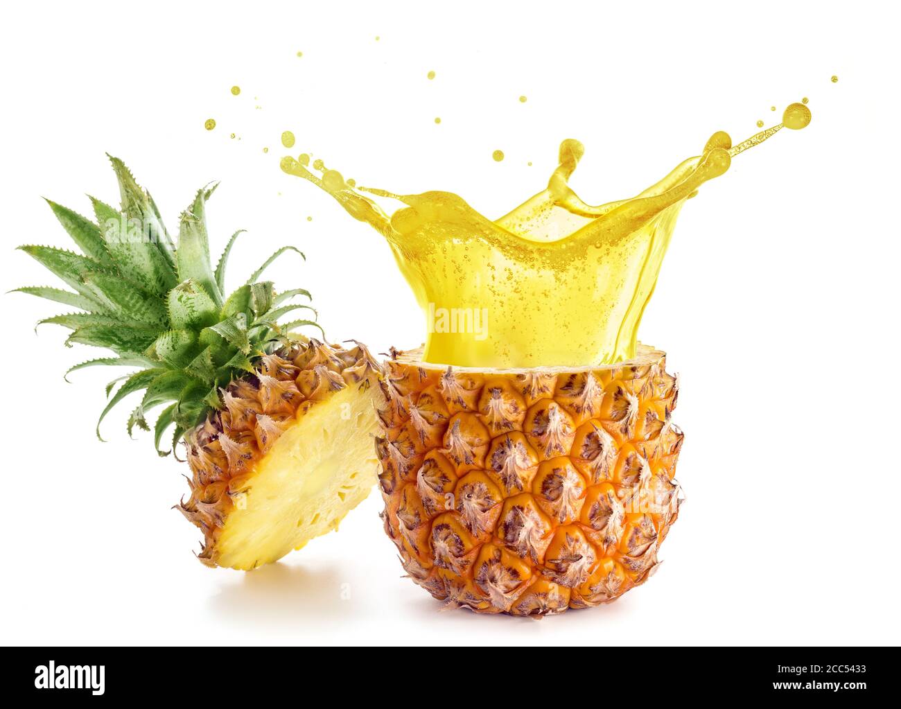yellow juice exploding out of a pineapple isolated on white background ...