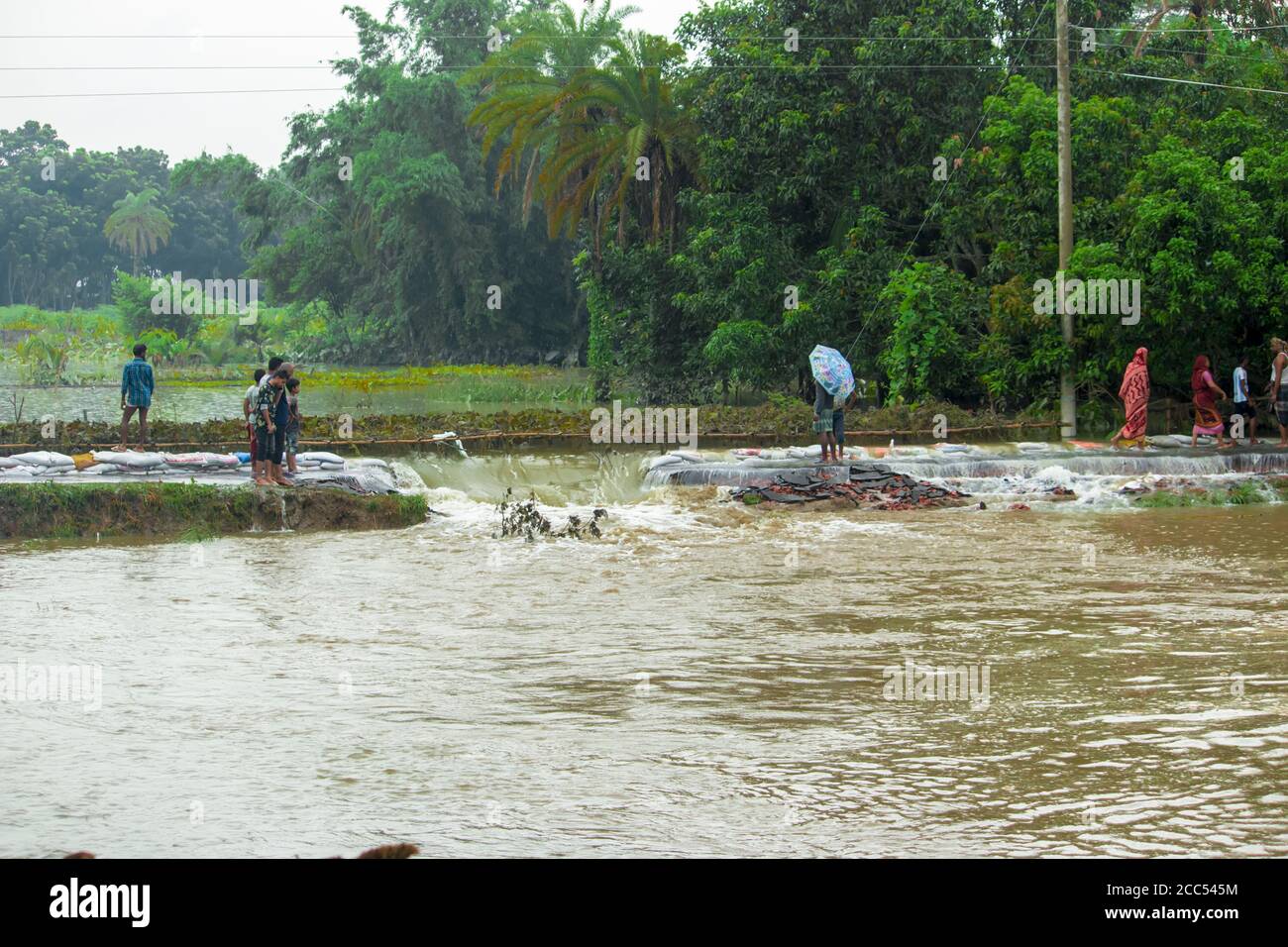 flood water over flowing on the way Stock Photo - Alamy