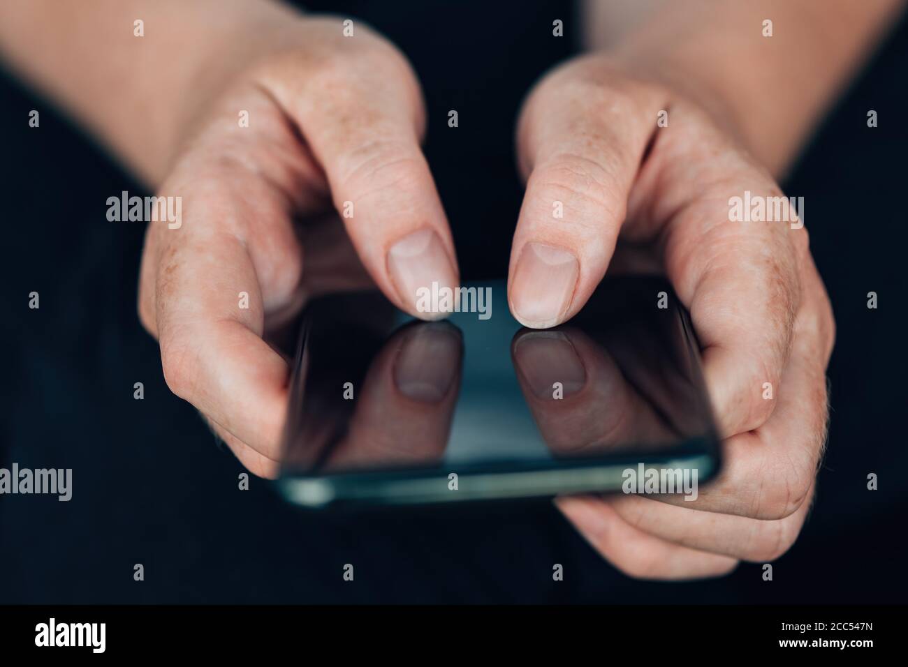 Female hands using modern mobile phone to type text message, selective ...