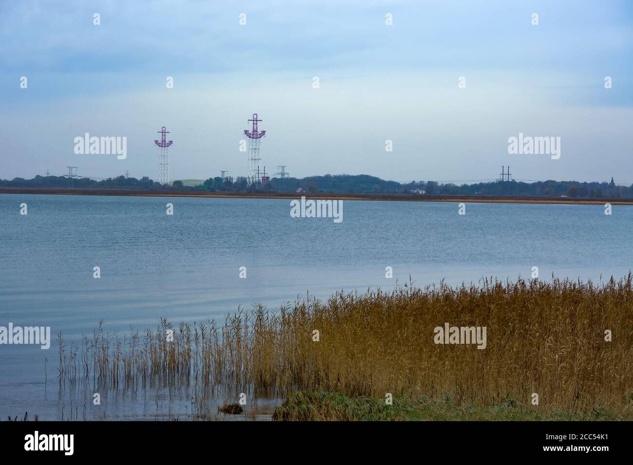 power line poles on the river, stylized as power line anchors, Russia ...