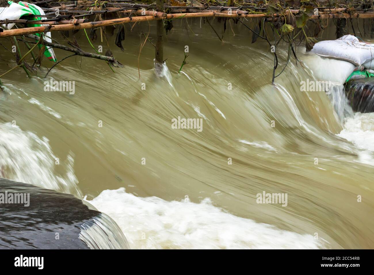 flood water over flowing on the way Stock Photo - Alamy