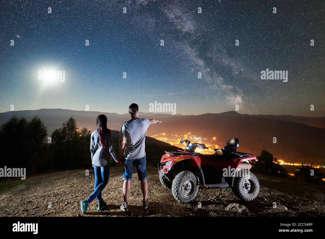 Back view of happy couple man and woman trevelers with atv quad ...