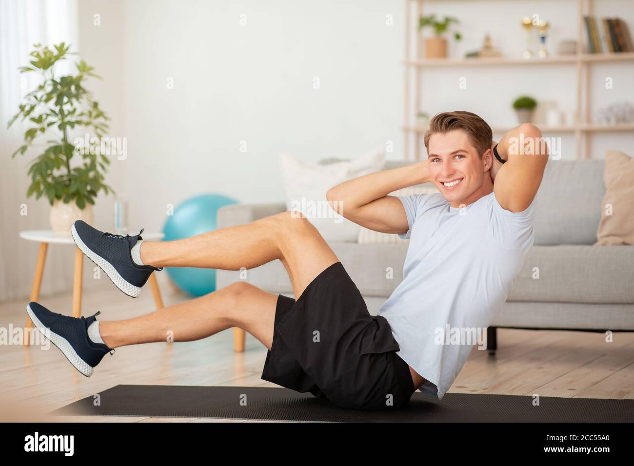 Simple workout at home to keep fit. Handsome guydoing exercises for ...