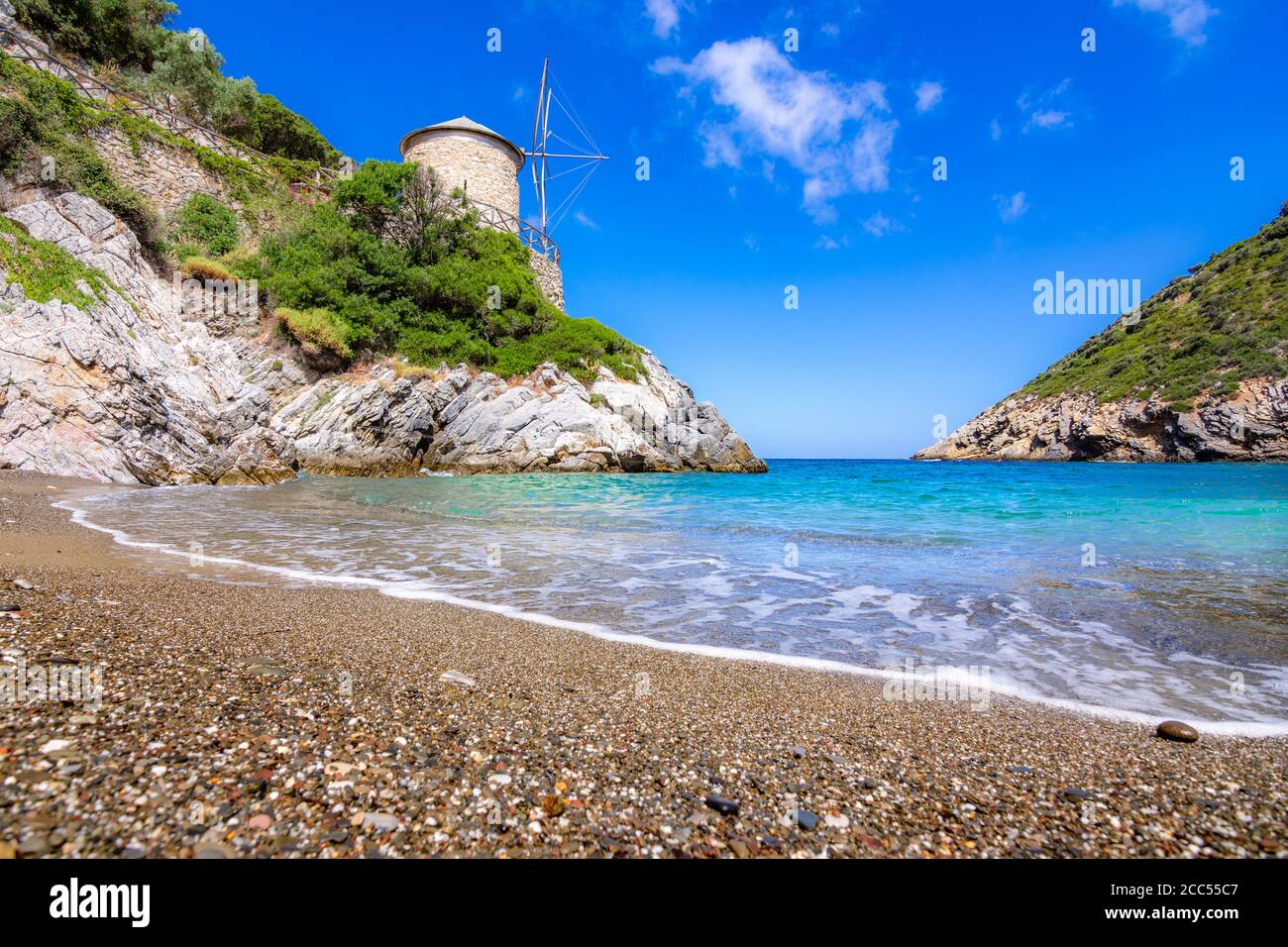 Gialia beach with old windmill in Alonnisos island, Greece Stock Photo ...
