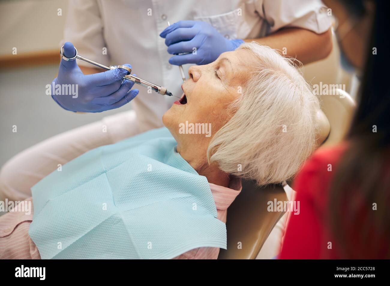 Doctor making injection to female visitor in dental clinic Stock Photo ...