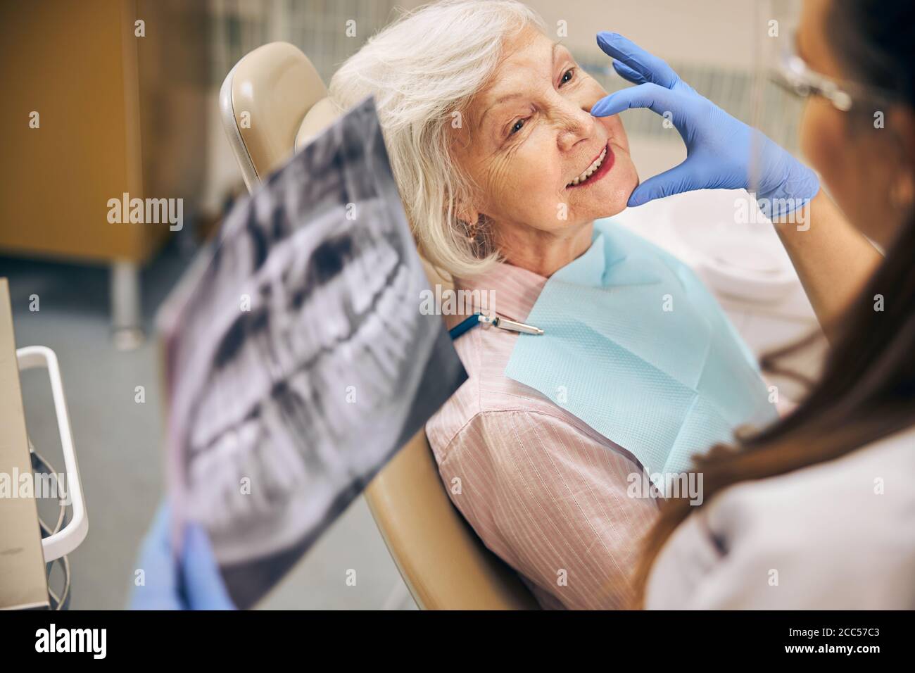 Happy lady making regular check up in modern clinic Stock Photo - Alamy