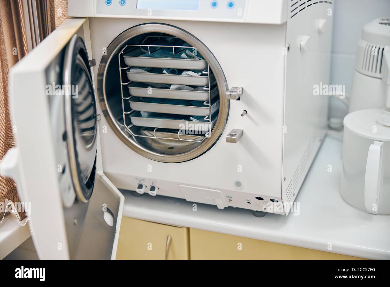 Sterilizing medical instruments in autoclave in medical clinic Stock ...