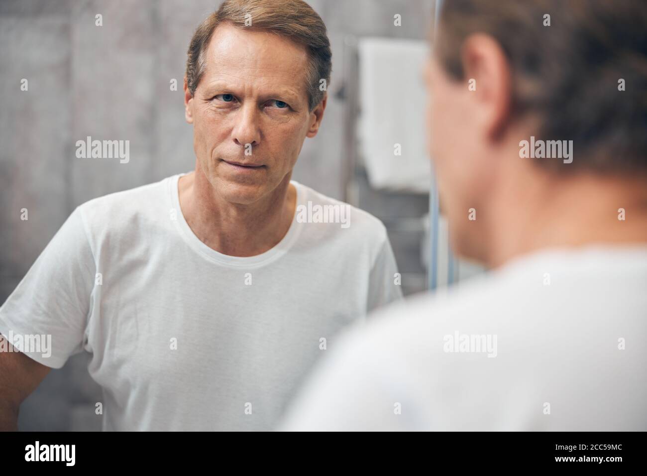 Focused male gazing intently at his face Stock Photo - Alamy