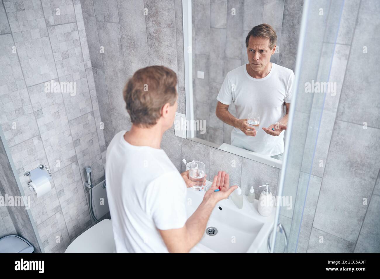 Person staring in mirror hi-res stock photography and images - Alamy