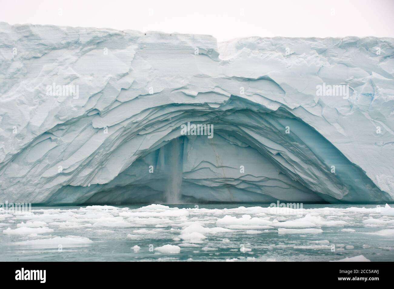 Collapsing ice cave in a glacier dug out by a meltwater river and ...
