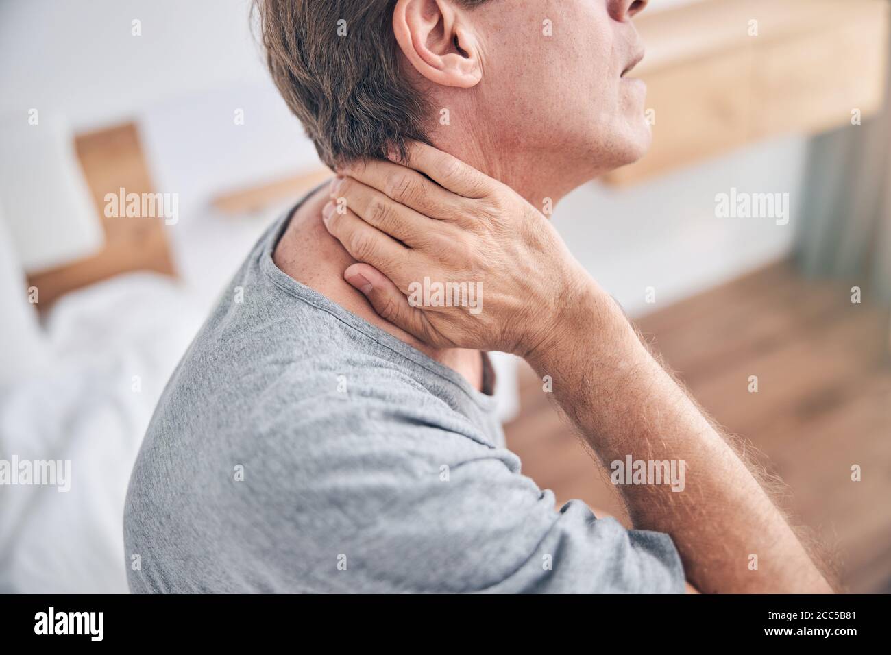 Hand touching neck hi-res stock photography and images - Alamy