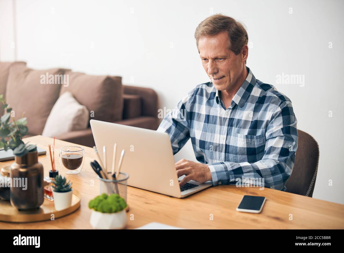 Attentive male person staring at screen of computer Stock Photo - Alamy