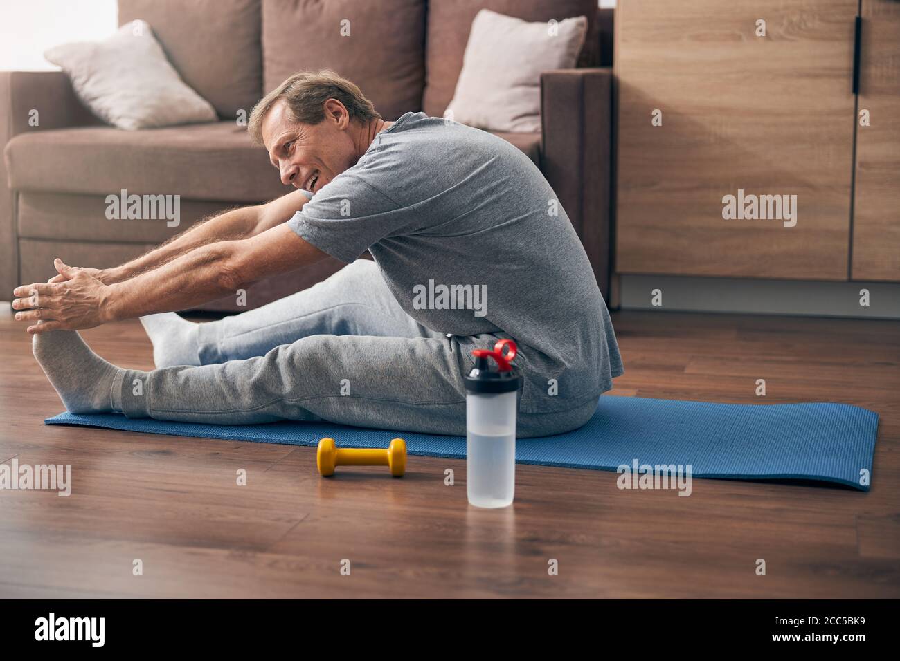 Cheerful male person working at his flexibility Stock Photo - Alamy