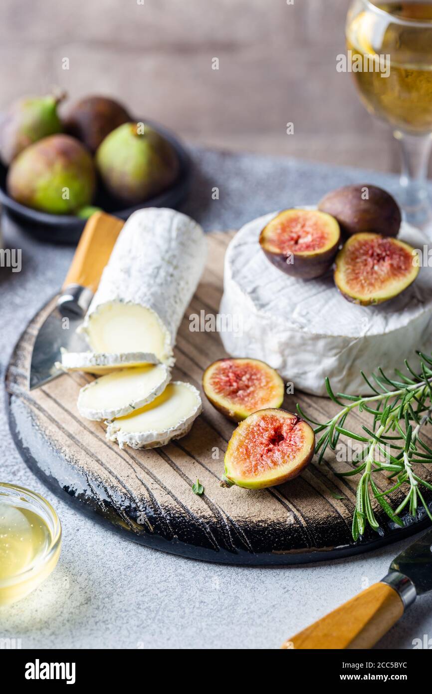 Fresh goat brie cheese with truffle and white mold on cheese platter ...