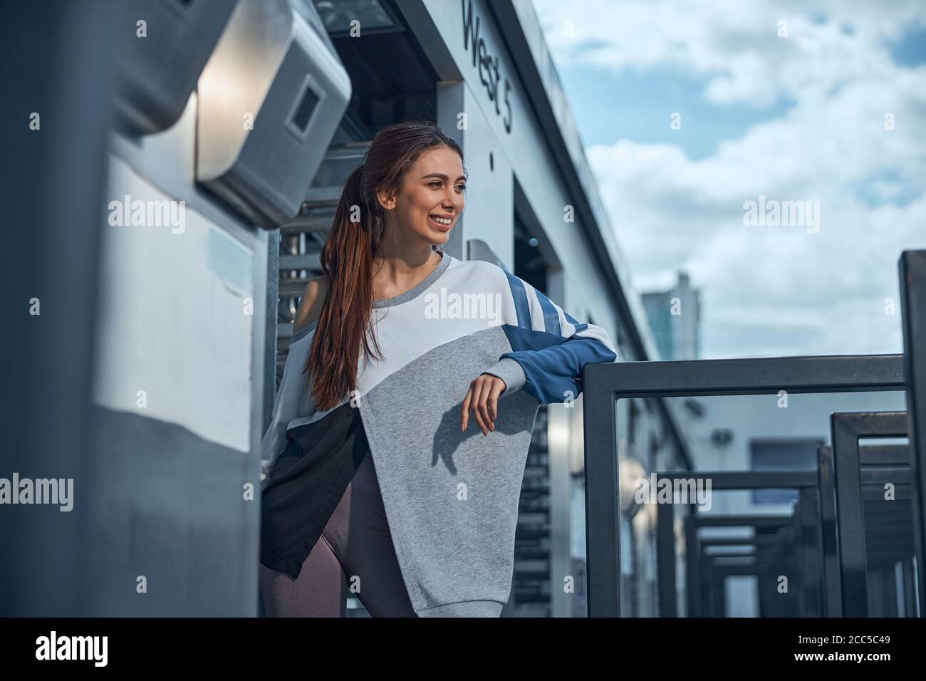 High-spirited woman with a ponytail gazing away Stock Photo - Alamy