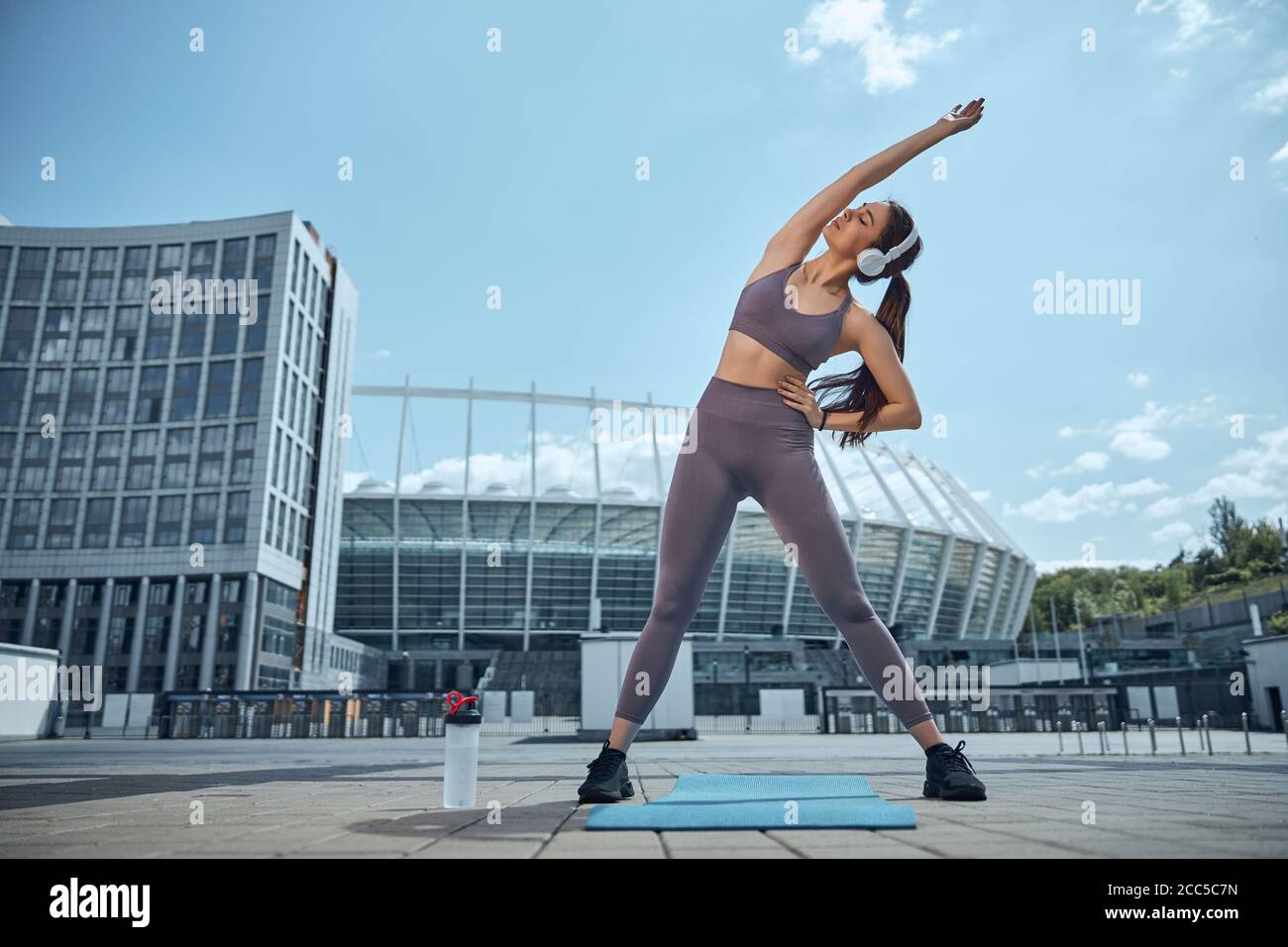 Serene sporty dark-haired Caucasian female bending sideways Stock Photo ...