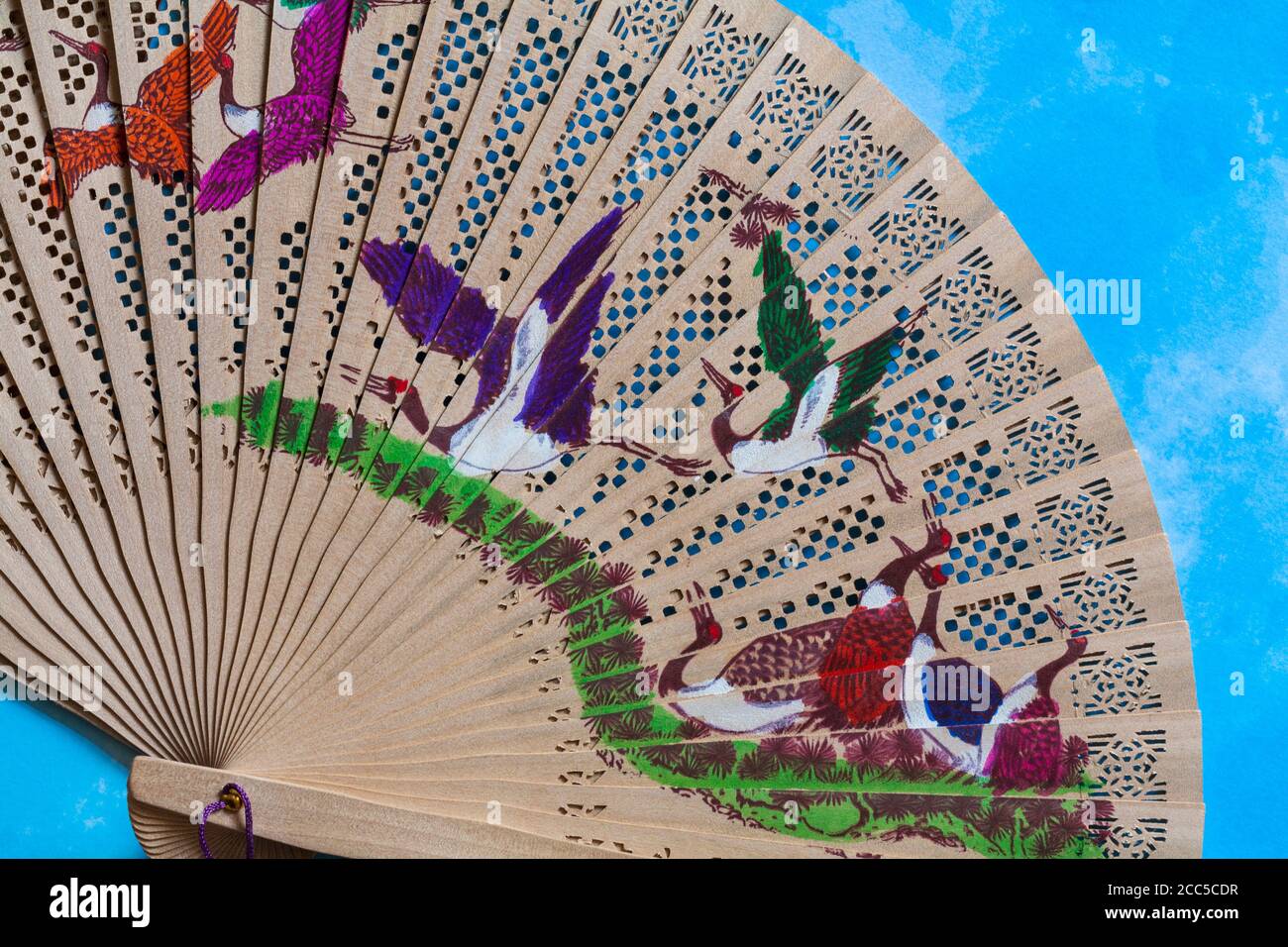 decorative hand held wooden bamboo fan from Myanmar (Burma) set against ...