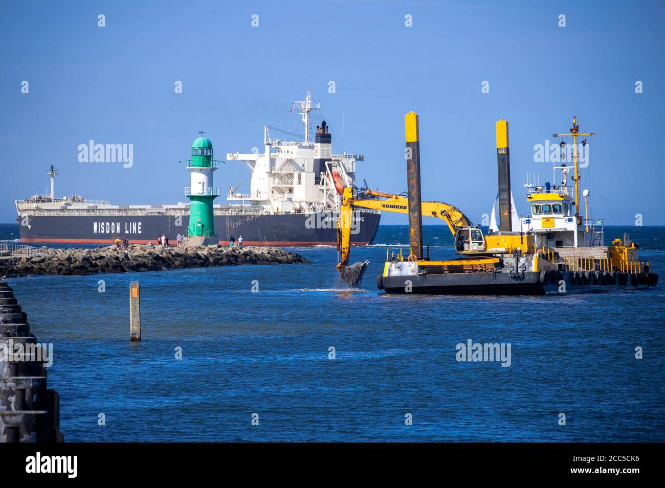 Rostock, Germany. 12th Aug, 2020. A cargo ship leaves the Rostock ...