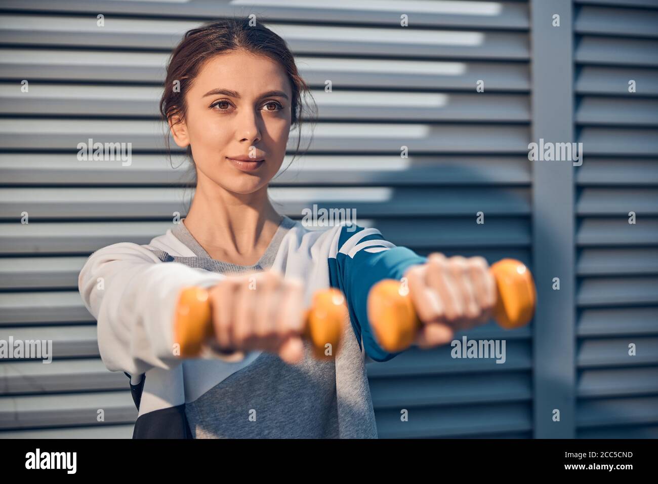 Female athlete performing a strength training exercise Stock Photo - Alamy
