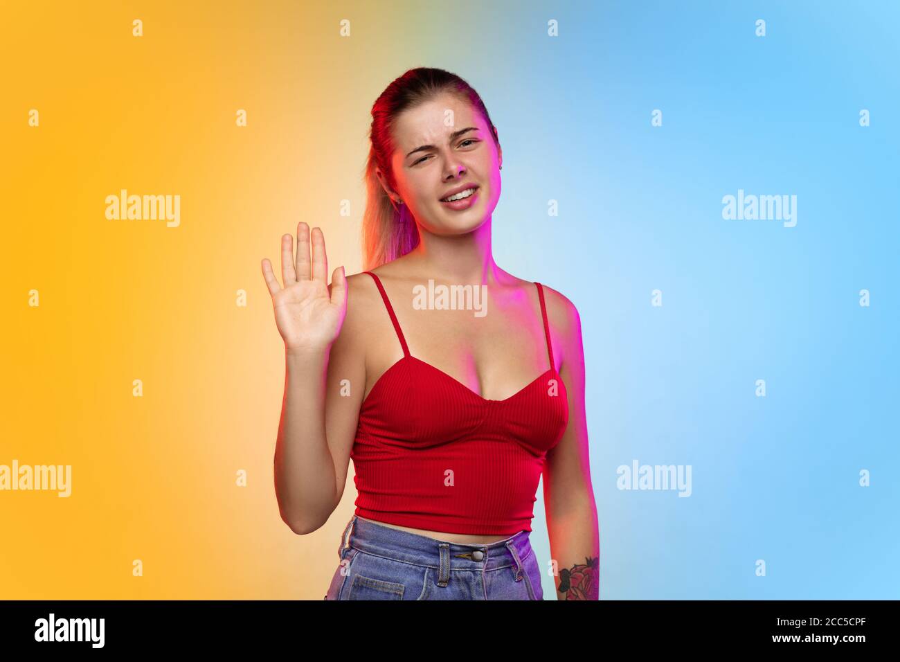 Bored greeting. Caucasian young woman's portrait on gradient studio ...