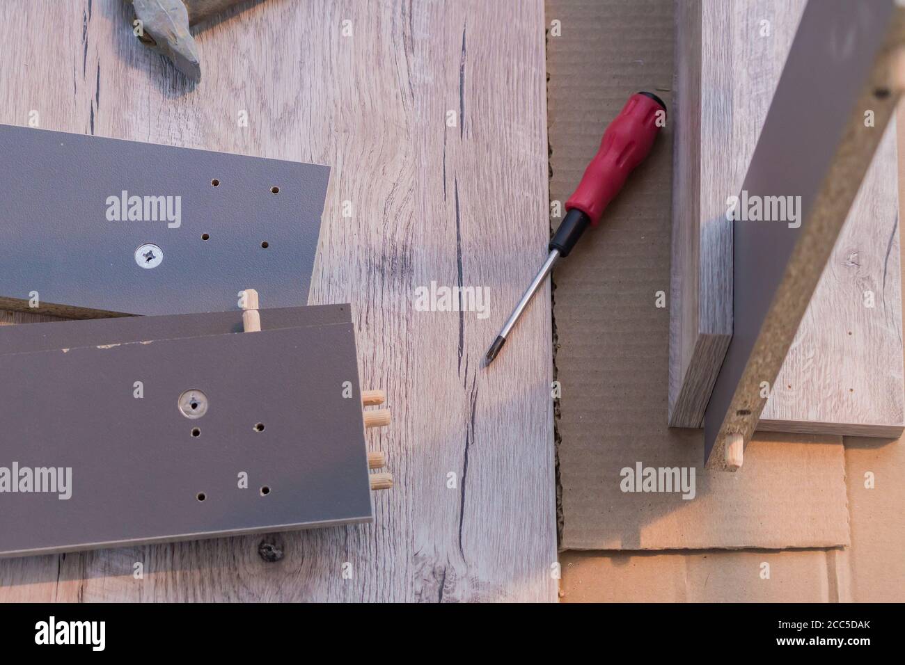 furniture assembling - screwdriver and table parts on the floor Stock ...