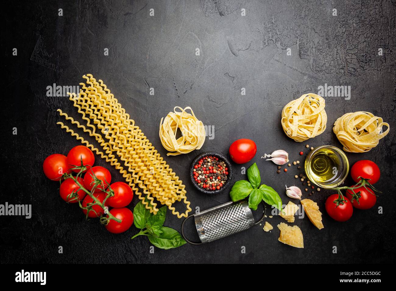 Pasta background. Several types of dry pasta with vegetables and herbs ...