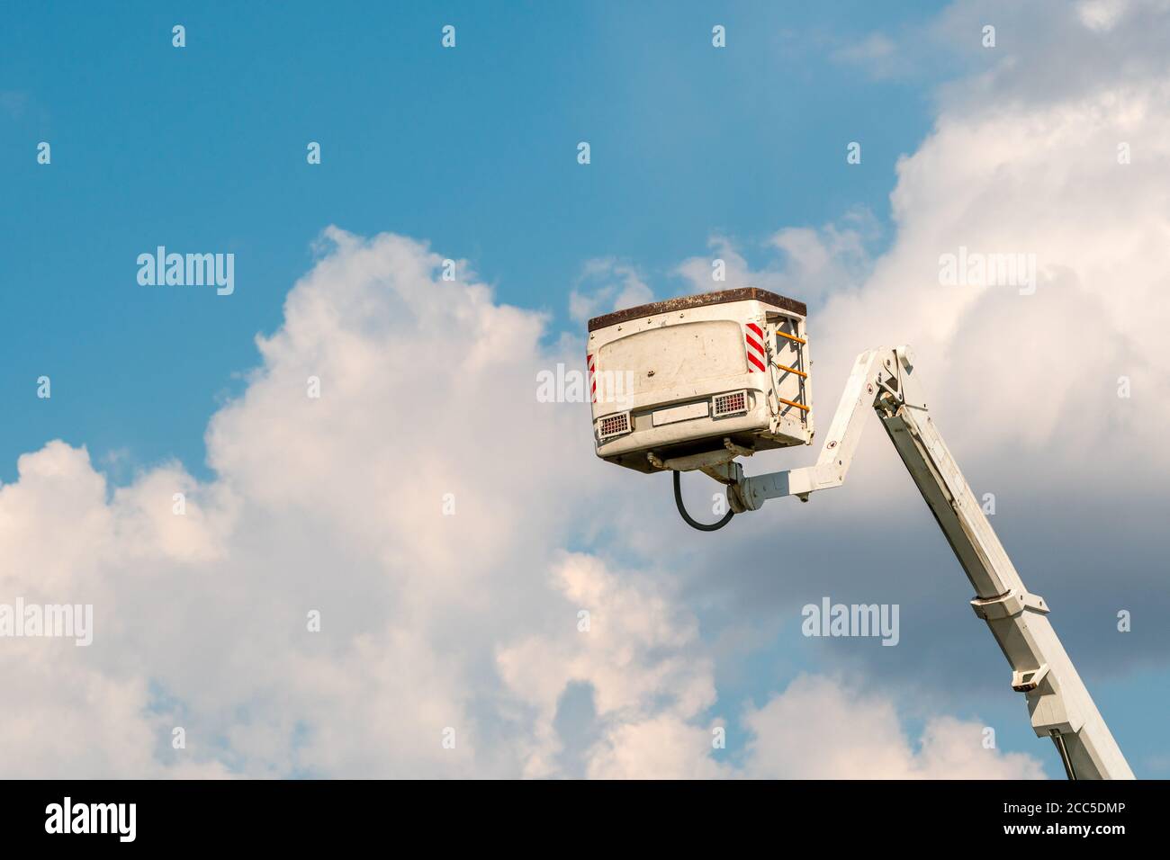 Aerial work platform lifted up against blue sky with clouds Stock Photo ...