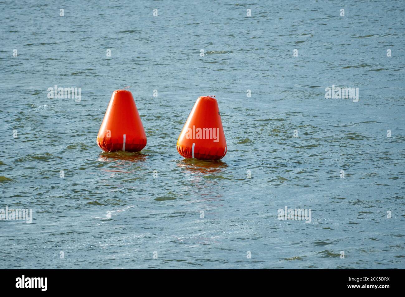 Inflatable orange buoys in a lake. Safety in a water Stock Photo - Alamy