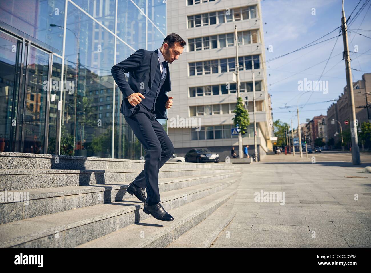 Happy handsome businessman walking down hi-res stock photography and ...