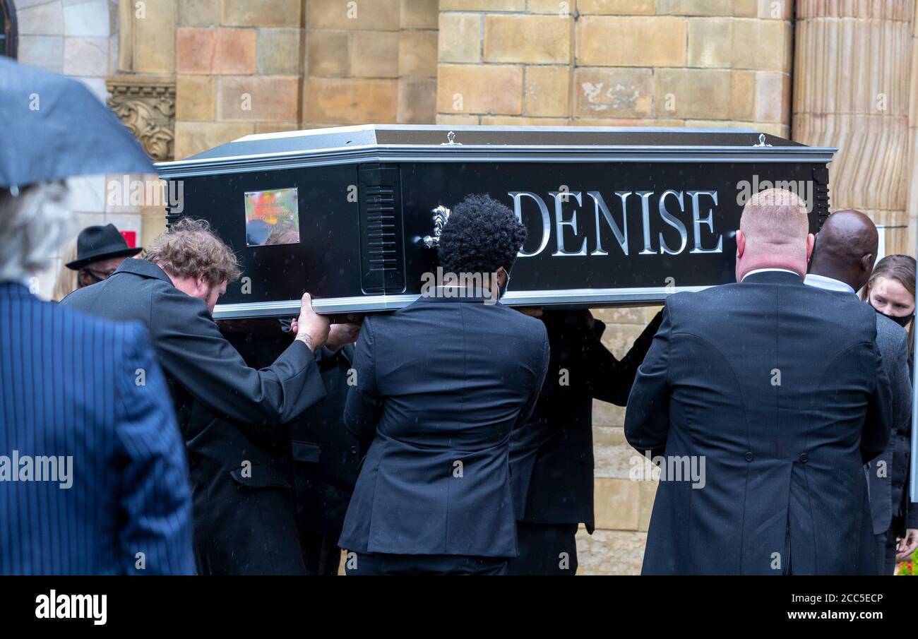 People carry the coffin outside Manchester Crematorium at the funeral ...