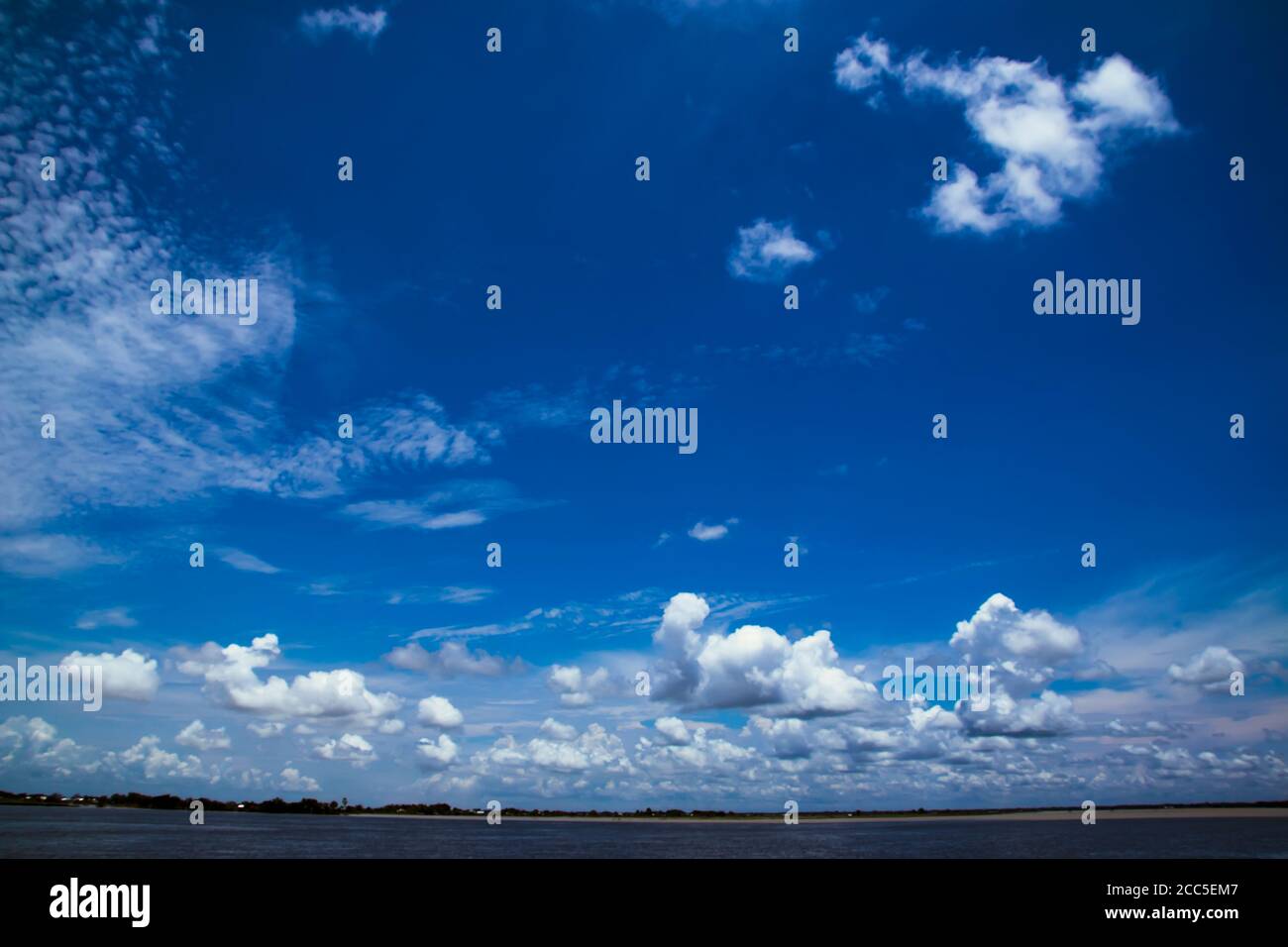 Blue sky background with tiny clouds Stock Photo - Alamy