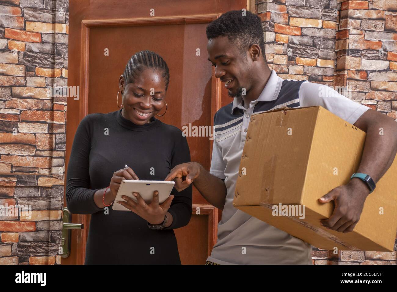 Signing for a parcel hi-res stock photography and images - Alamy