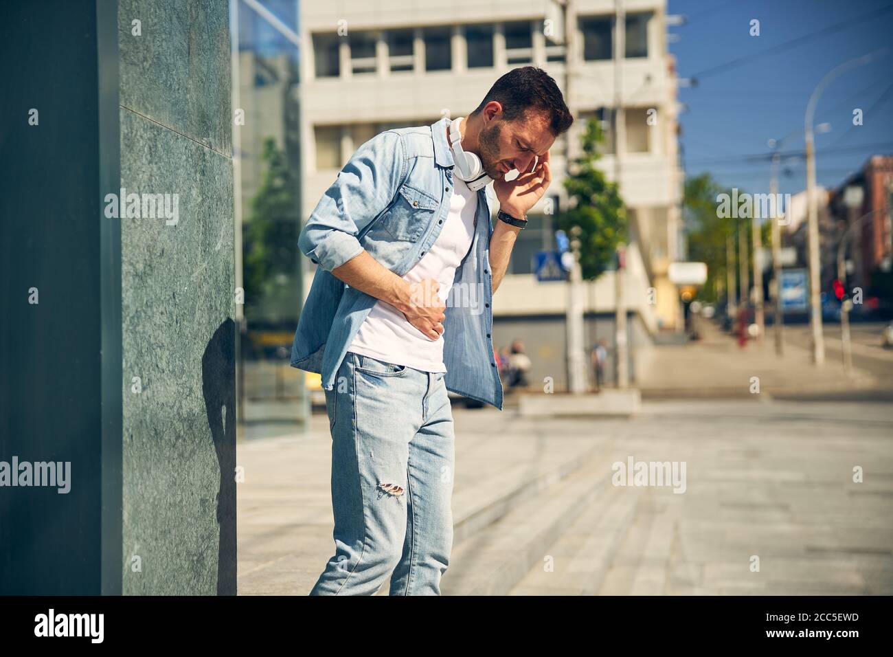 Concentrated male person looking downwards at stairs Stock Photo - Alamy