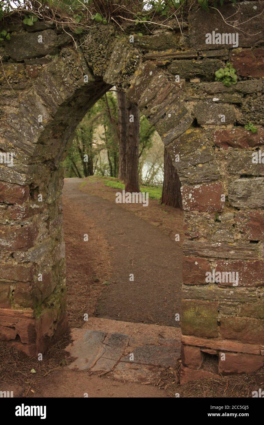 Stone archway with path through the woods, Brixham, Devon, UK Stock ...