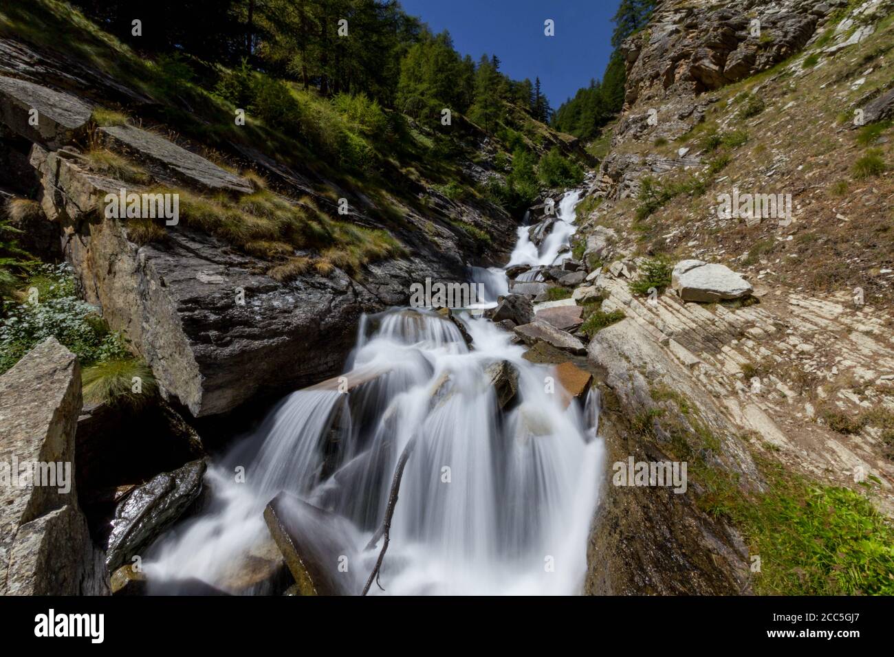 Waterfall in the Alps Stock Photo - Alamy