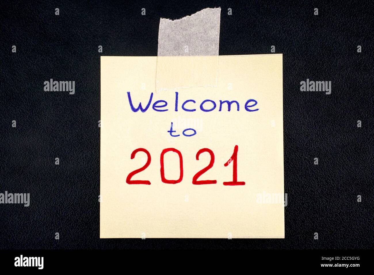Note with words Welcome to 2021 attaches on blackboard Stock Photo - Alamy