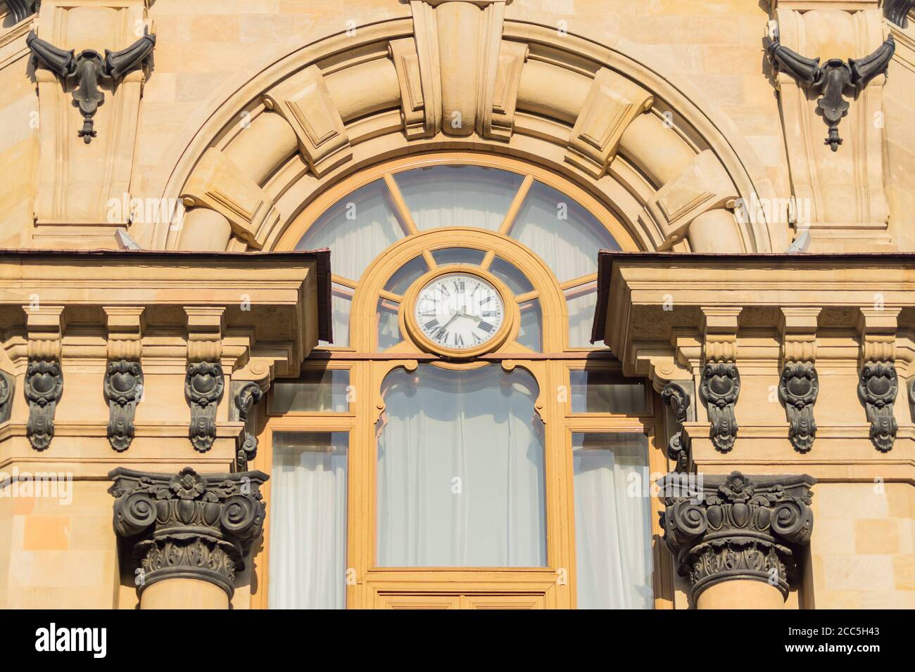 clock on the building's facade Stock Photo - Alamy