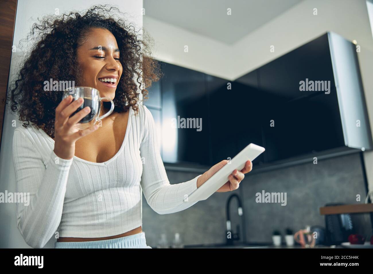 Beautiful lady with dark hair laughing at home Stock Photo - Alamy