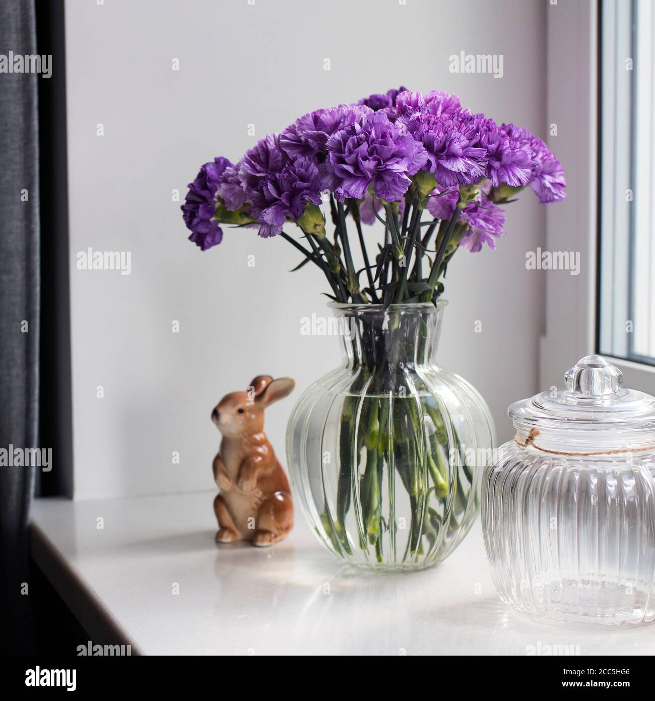 Bridal bouquets of lilac carnations in a round glass vase different ...