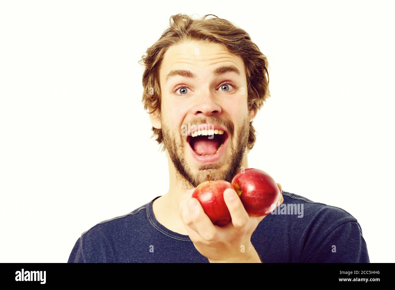 Man laughing and holding red apples in his hand, isolated on white ...