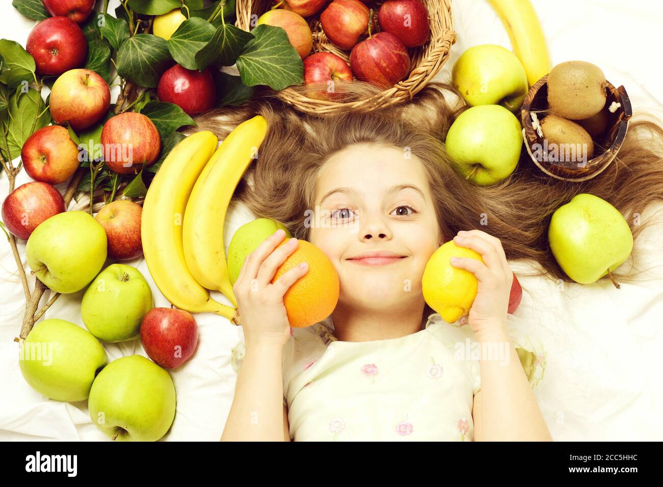 small happy girl eating exotic fruit or summer background Stock Photo ...