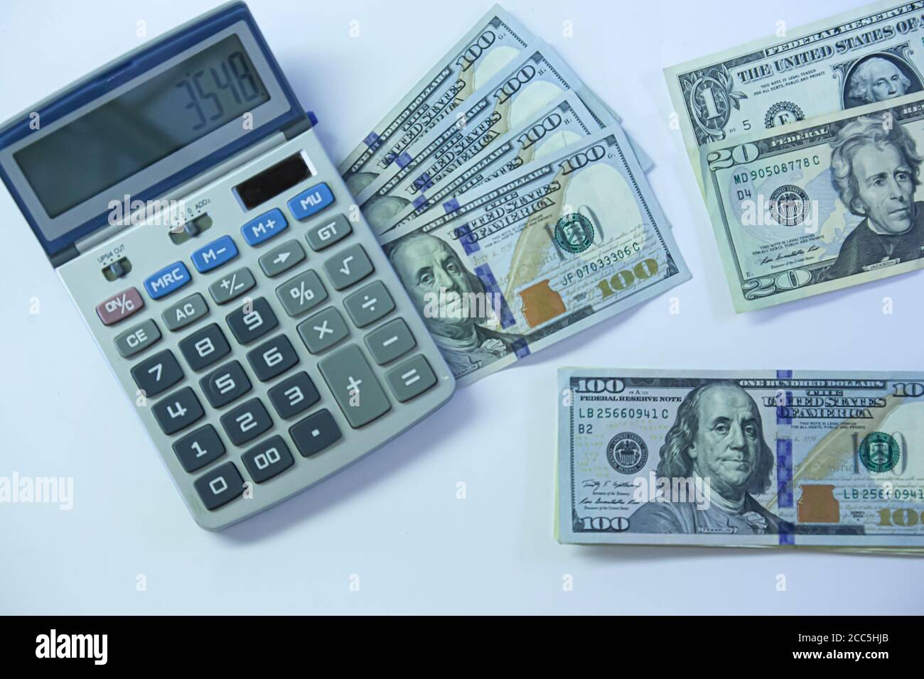 Dollar notes and calculator 4 Stock Photo - Alamy
