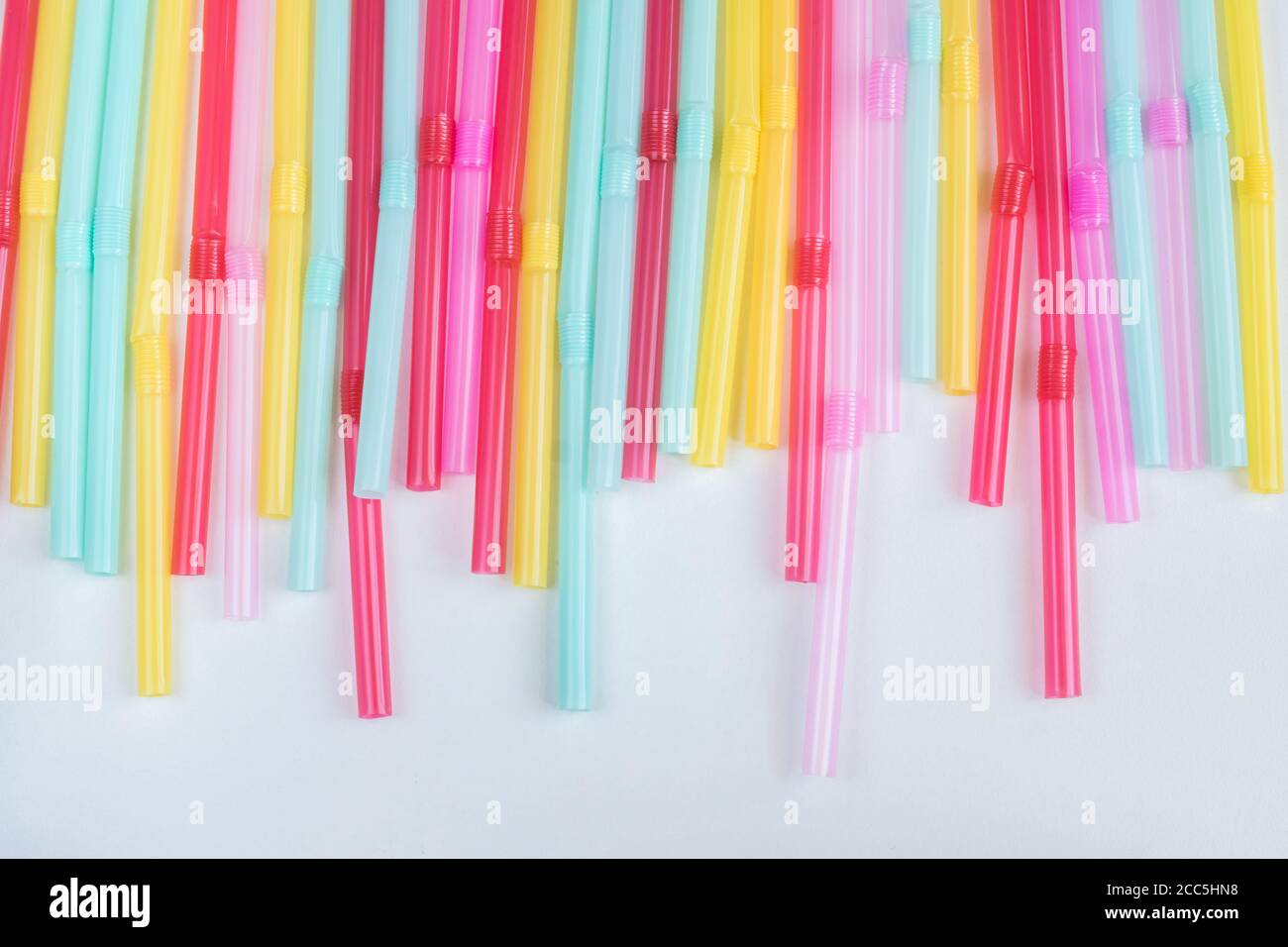 blue, pink and yellow straws for cocktails and other drinks isolated on ...