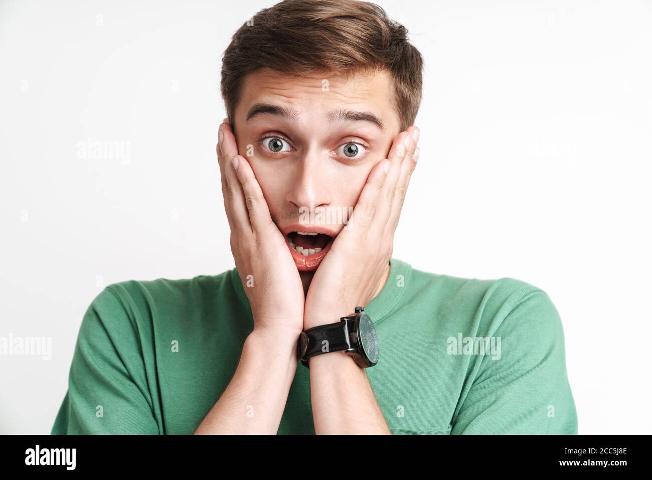 Image of displeased caucasian man in basic t-shirt being stressed and ...
