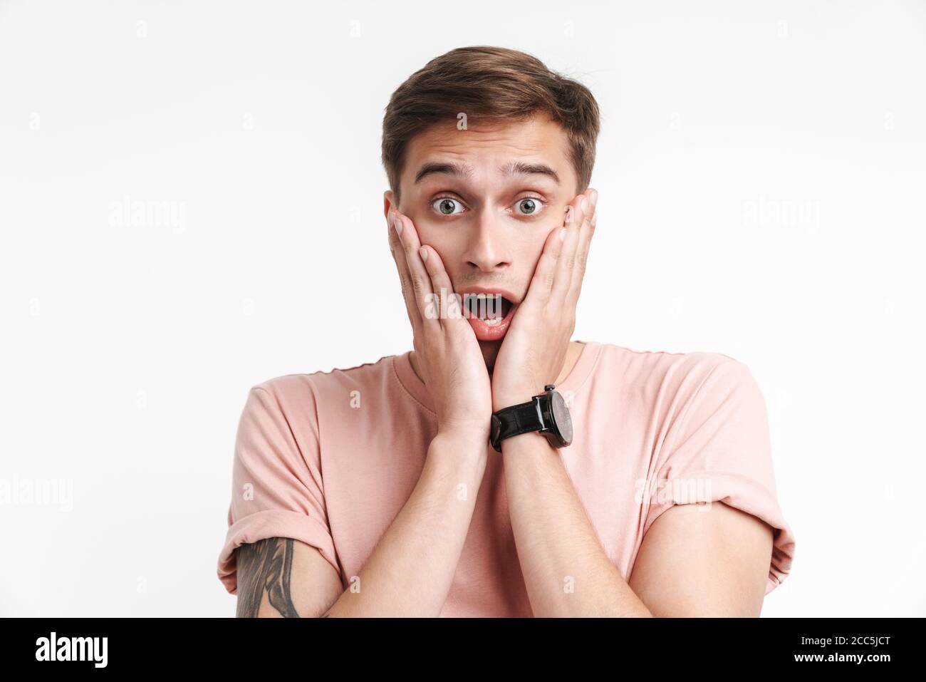 Image of intimidated caucasian man in basic t-shirt being stressed and ...