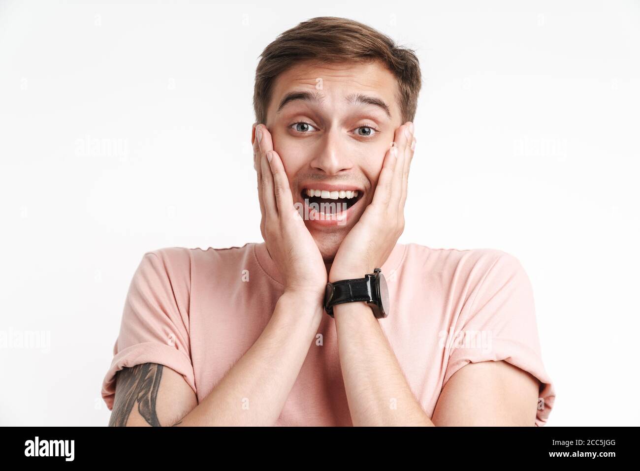 Image of excited caucasian man in basic t-shirt smiling and grabbing ...